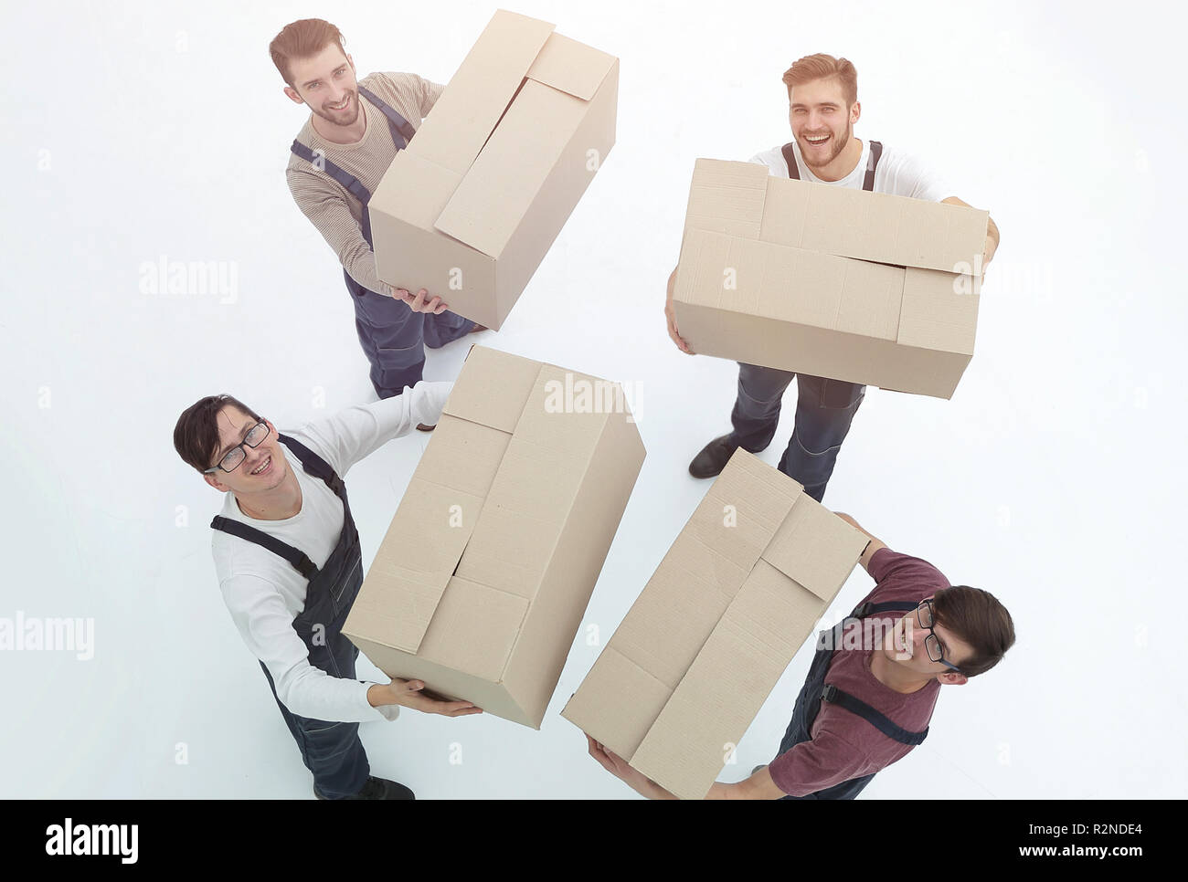 Movers lifting stack of cardboard moving boxes isolated on white Stock ...