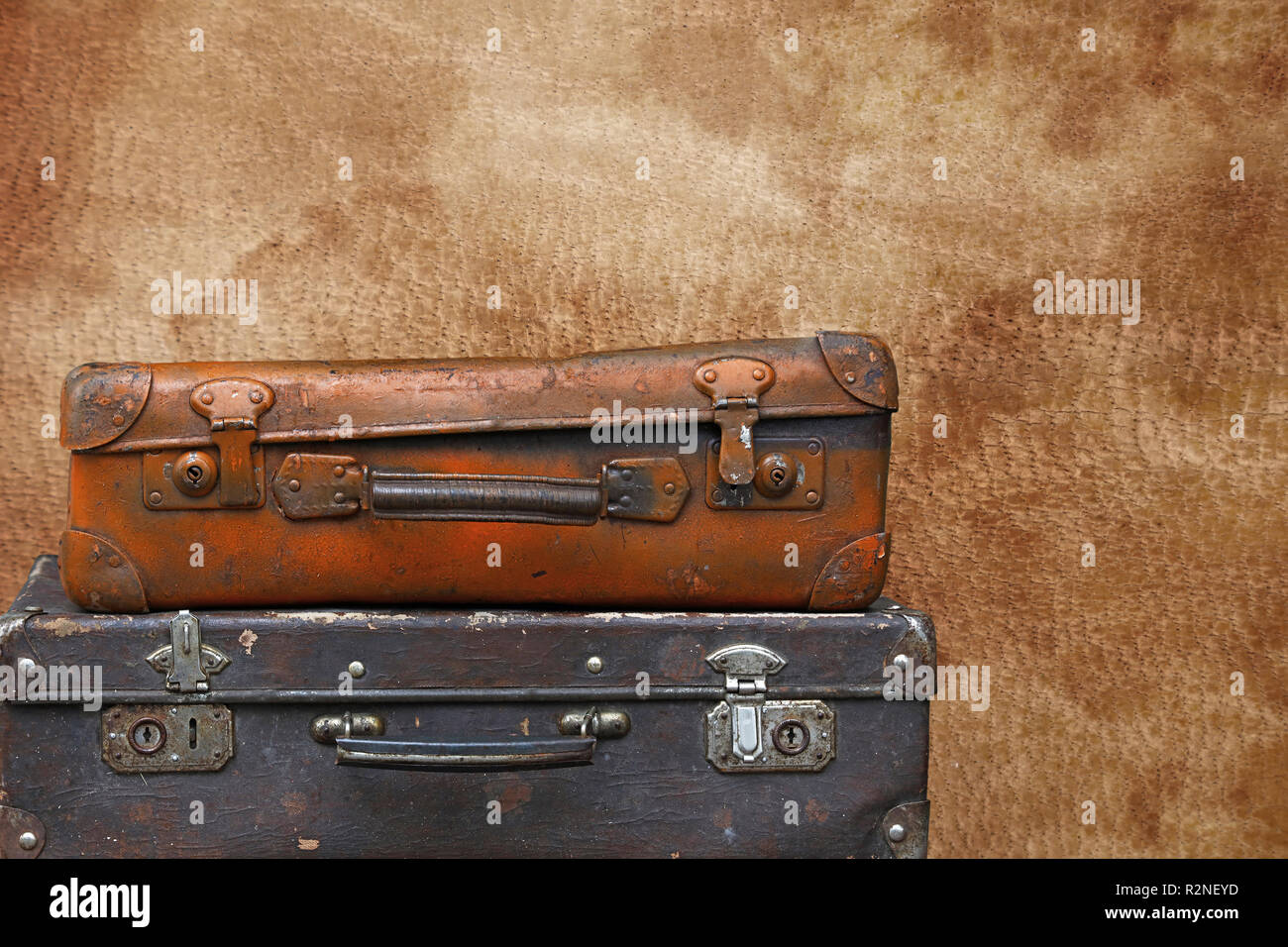 Close up stack of two old vintage antique grunge travel luggage brown ...