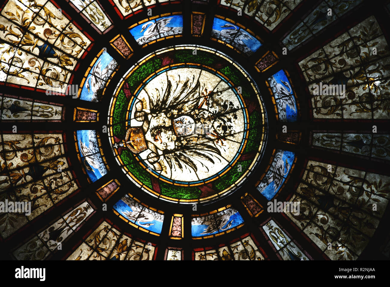 The colorful painted motives on the windows of the entrance dome of the ...