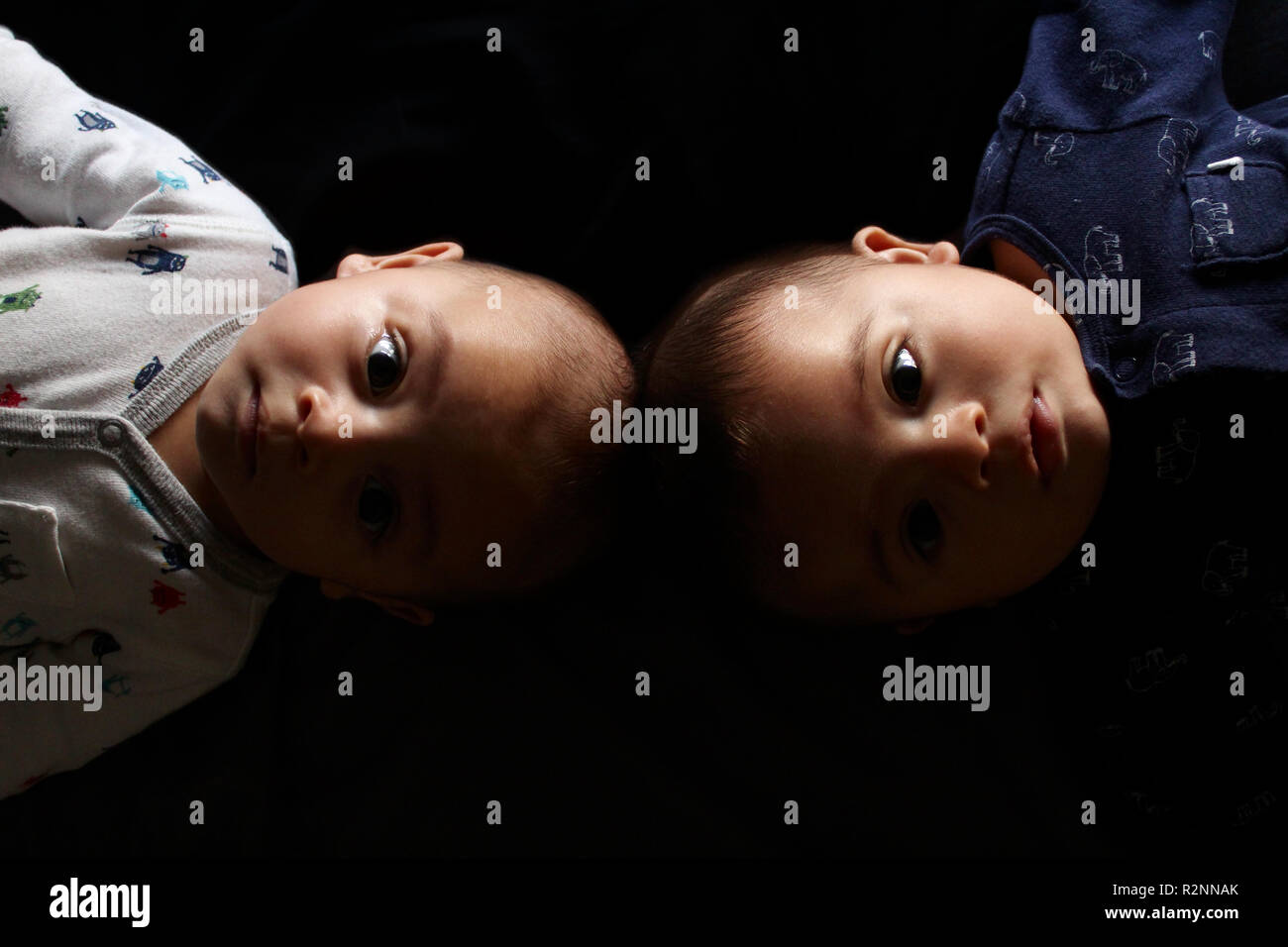 Baby twin brothers in the darkness Stock Photo - Alamy