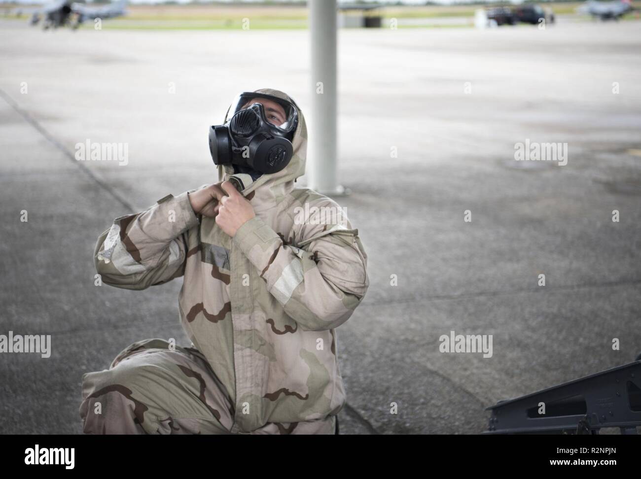 An airman with the 187th Aircraft Maintenance Squadron, dons gas mask ...