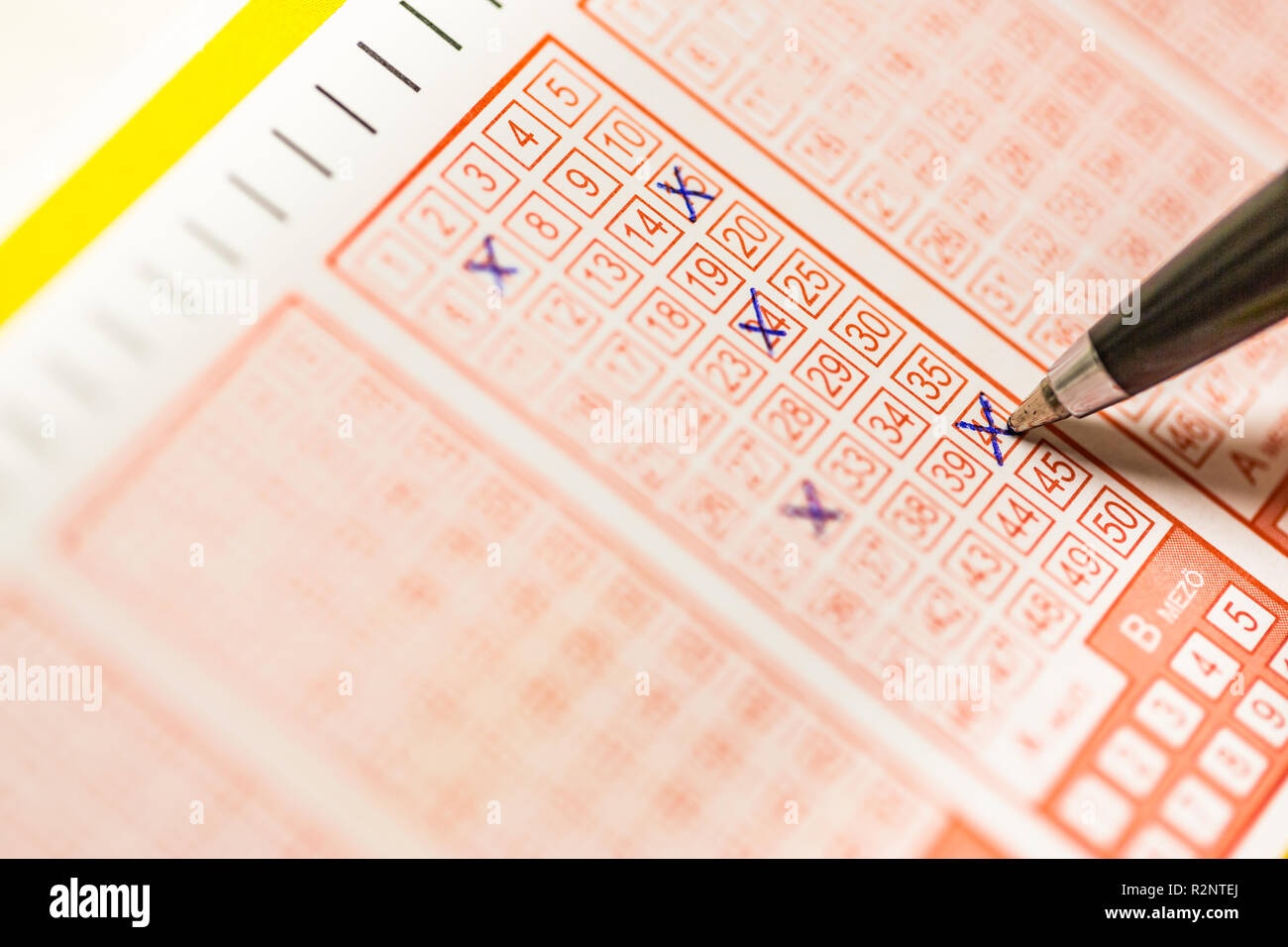 Close-up Of Person's Hand Marking Number On Lottery Ticket With Pen ...