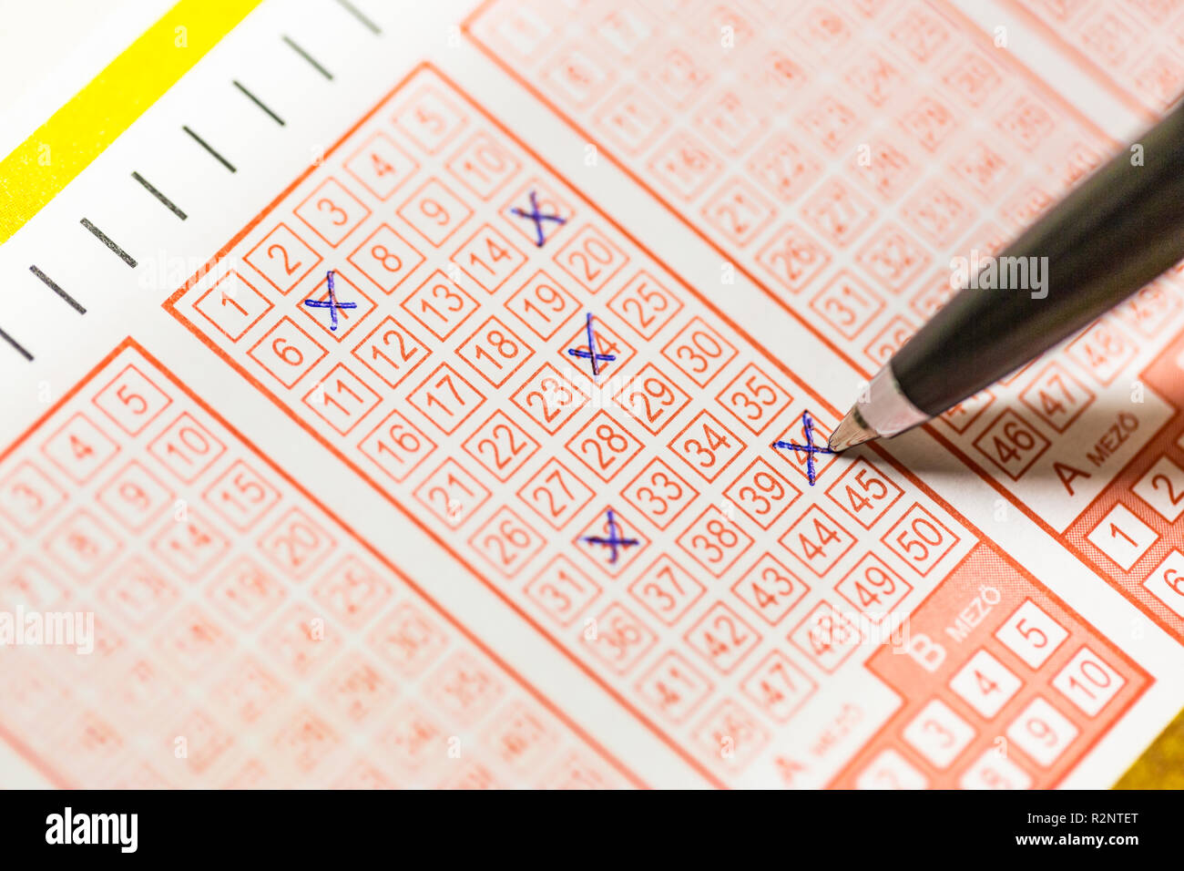 Close-up Of Person's Hand Marking Number On Lottery Ticket With Pen ...