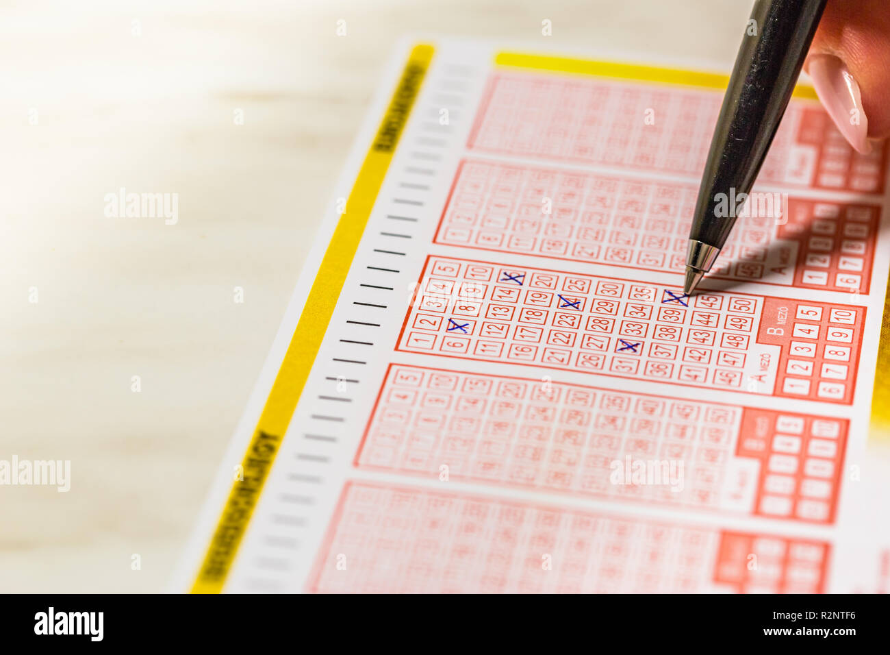 Close-up Of Person's Hand Marking Number On Lottery Ticket With Pen ...
