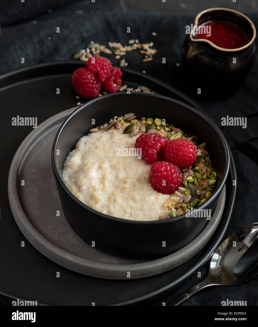 Breakfast porridge with fruit and nuts in dark setting Stock Photo - Alamy