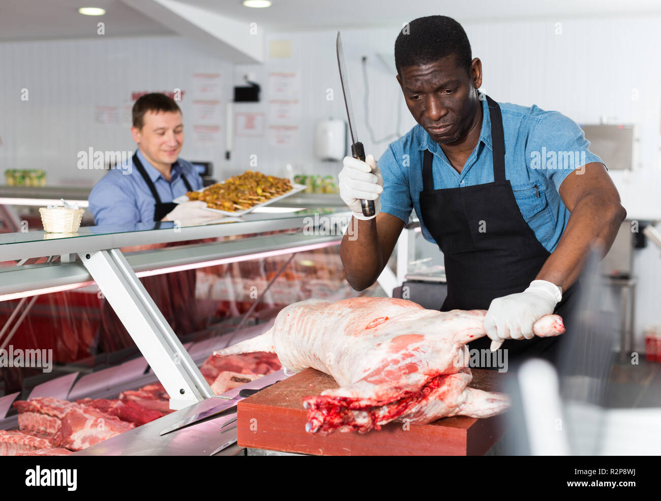 Butcher cutting meat african man hi-res stock photography and images ...