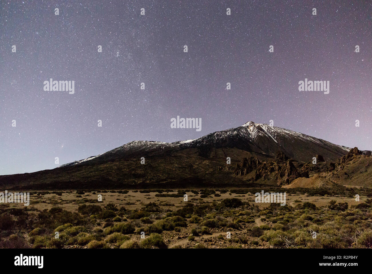 Starry sky above snow-covered Mount Teide with brightened foreground ...