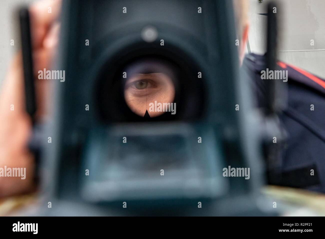 A Spanish sailor takes a bearing of the Amphibious Task force vessels ...
