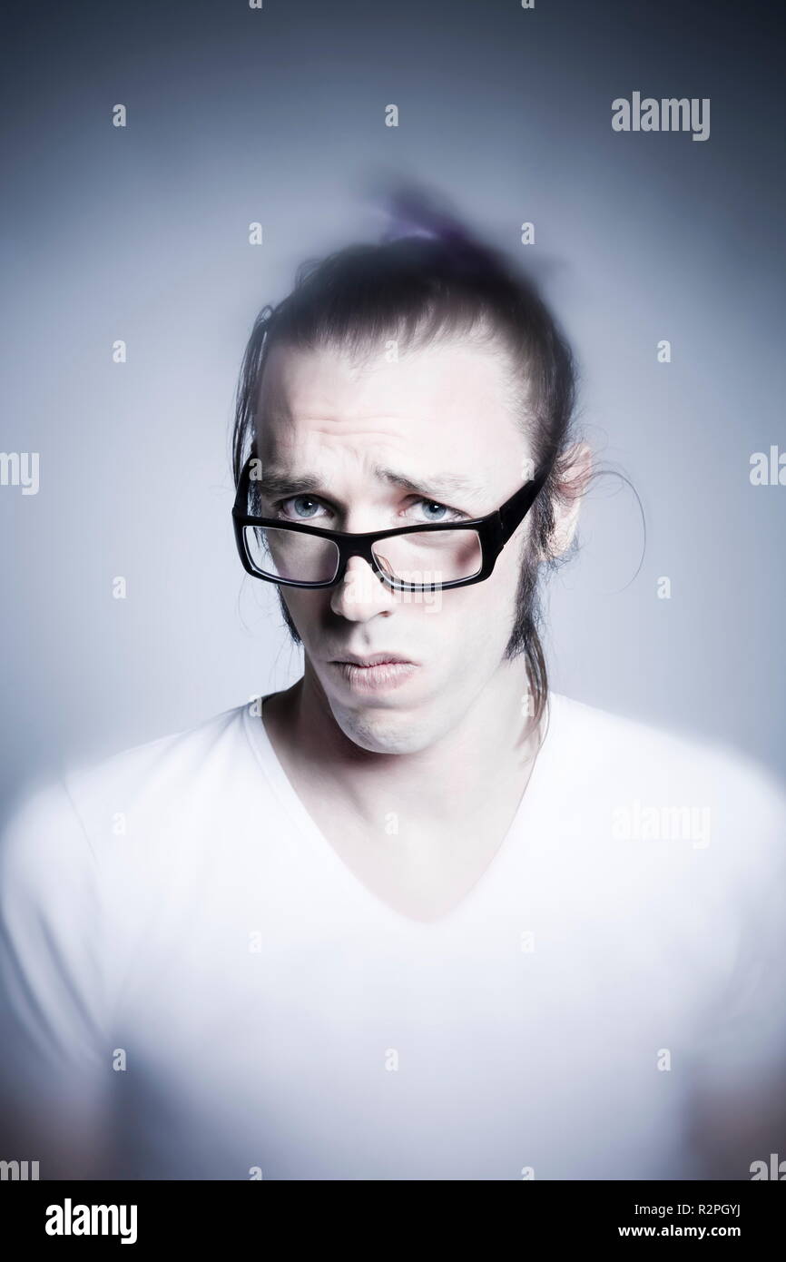 studio shot portrait of young expressive man making faces Stock Photo ...