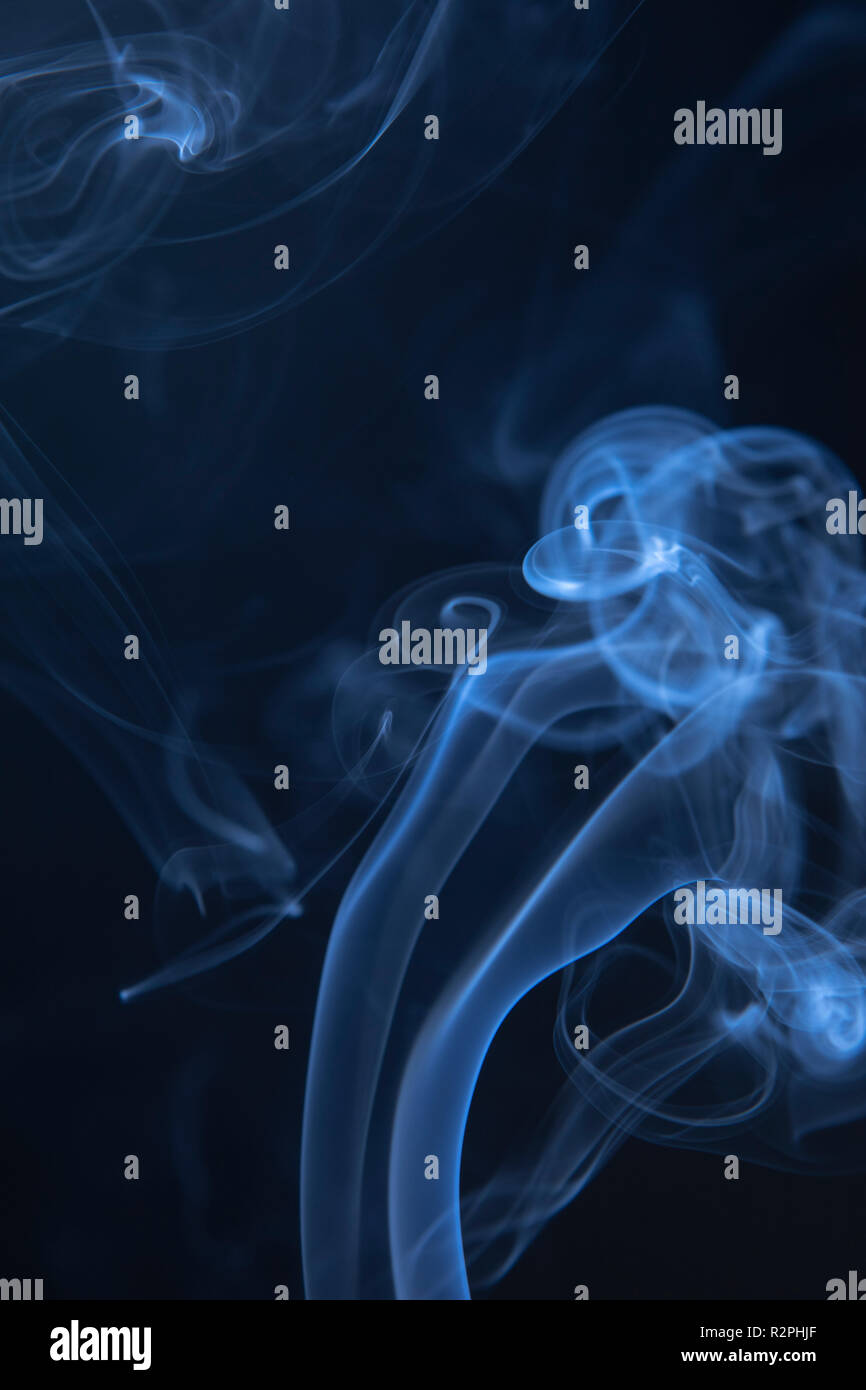 Abstract blue smoke swirls on dark background Stock Photo - Alamy