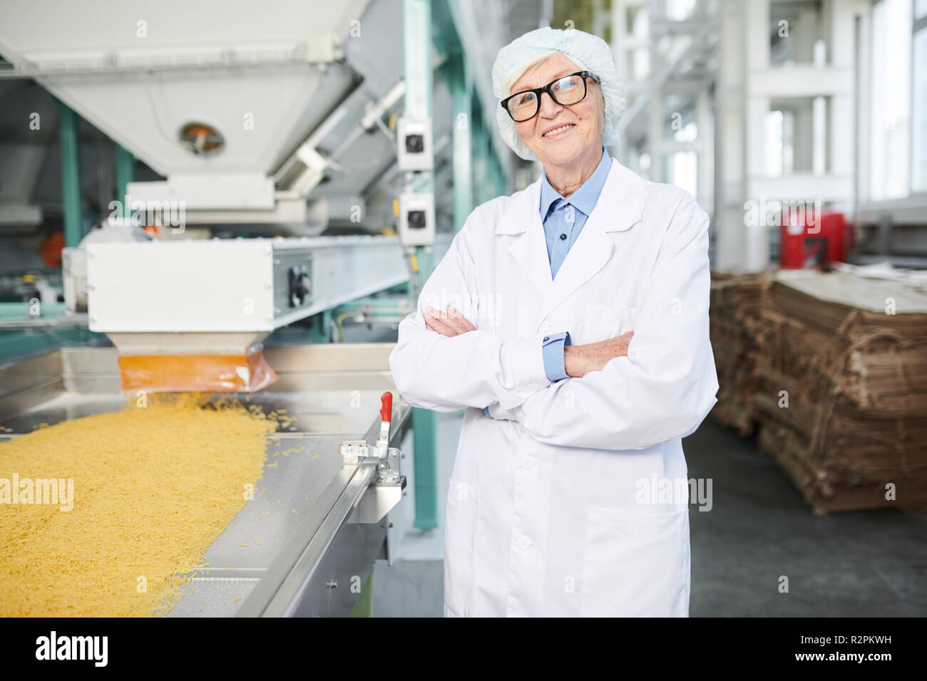 Happy Senior Woman Posing at Factory Stock Photo - Alamy