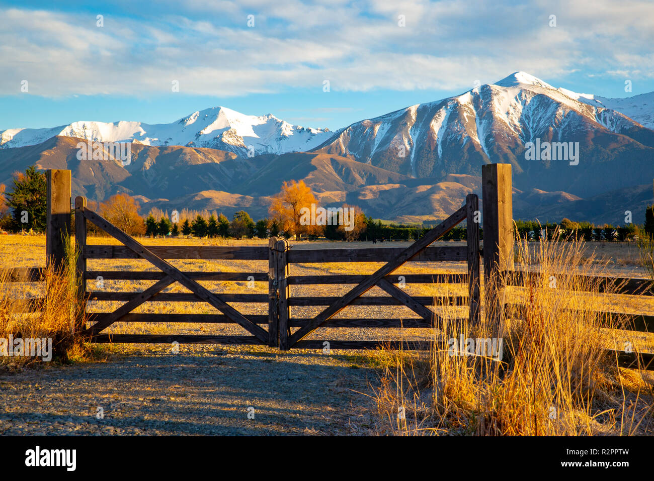 A closed wooden farm gate at the entrance to a farm in the high country ...