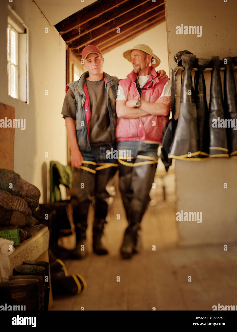 Two men standing together inside a house Stock Photo - Alamy