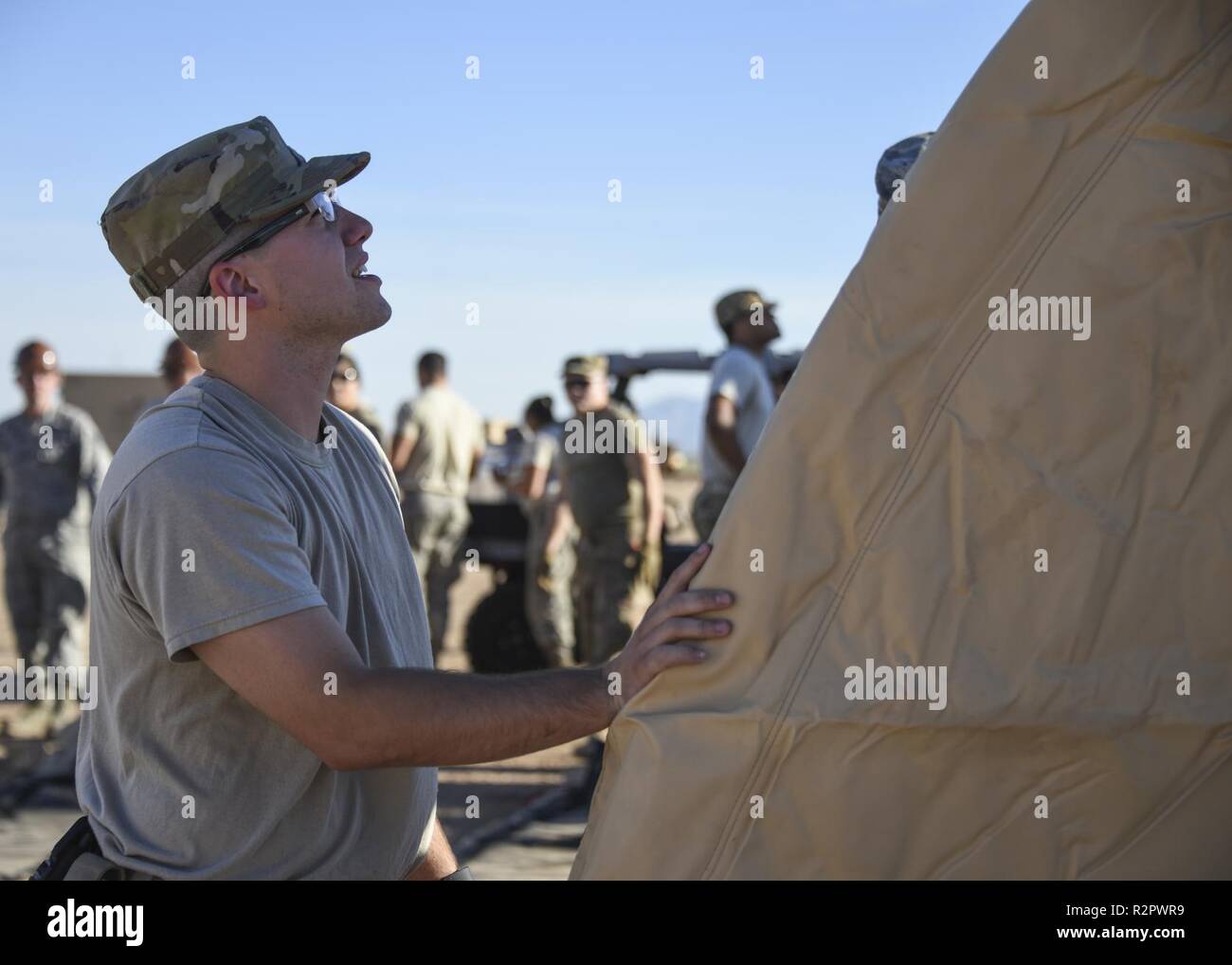 U.S. Air Force Airmen work together to set up tents for Sunglow City at ...