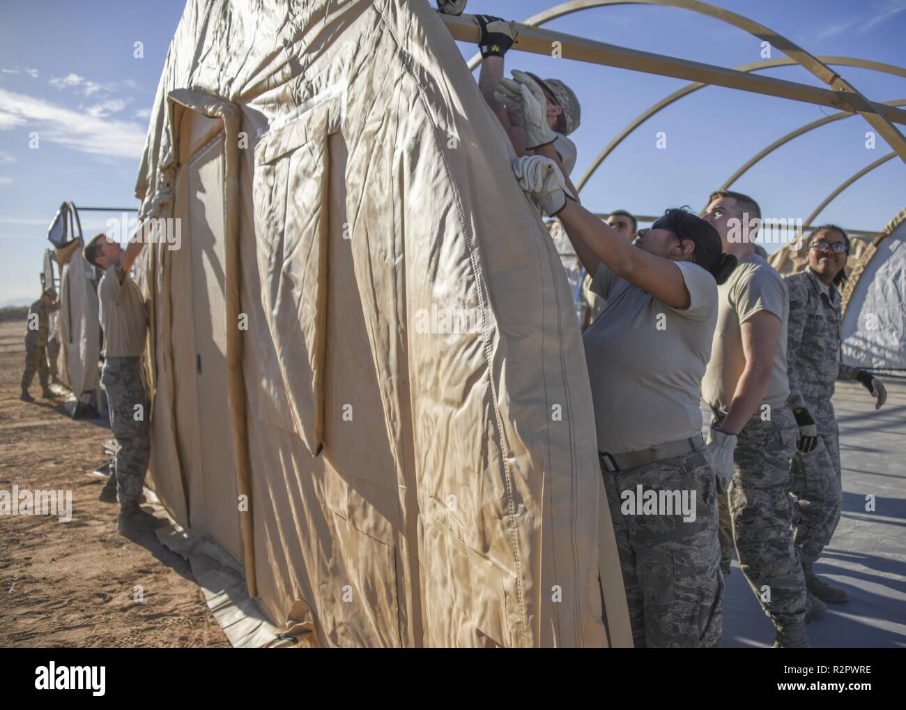 U.S. Air Force Airmen work together to set up tents for Sunglow City at ...