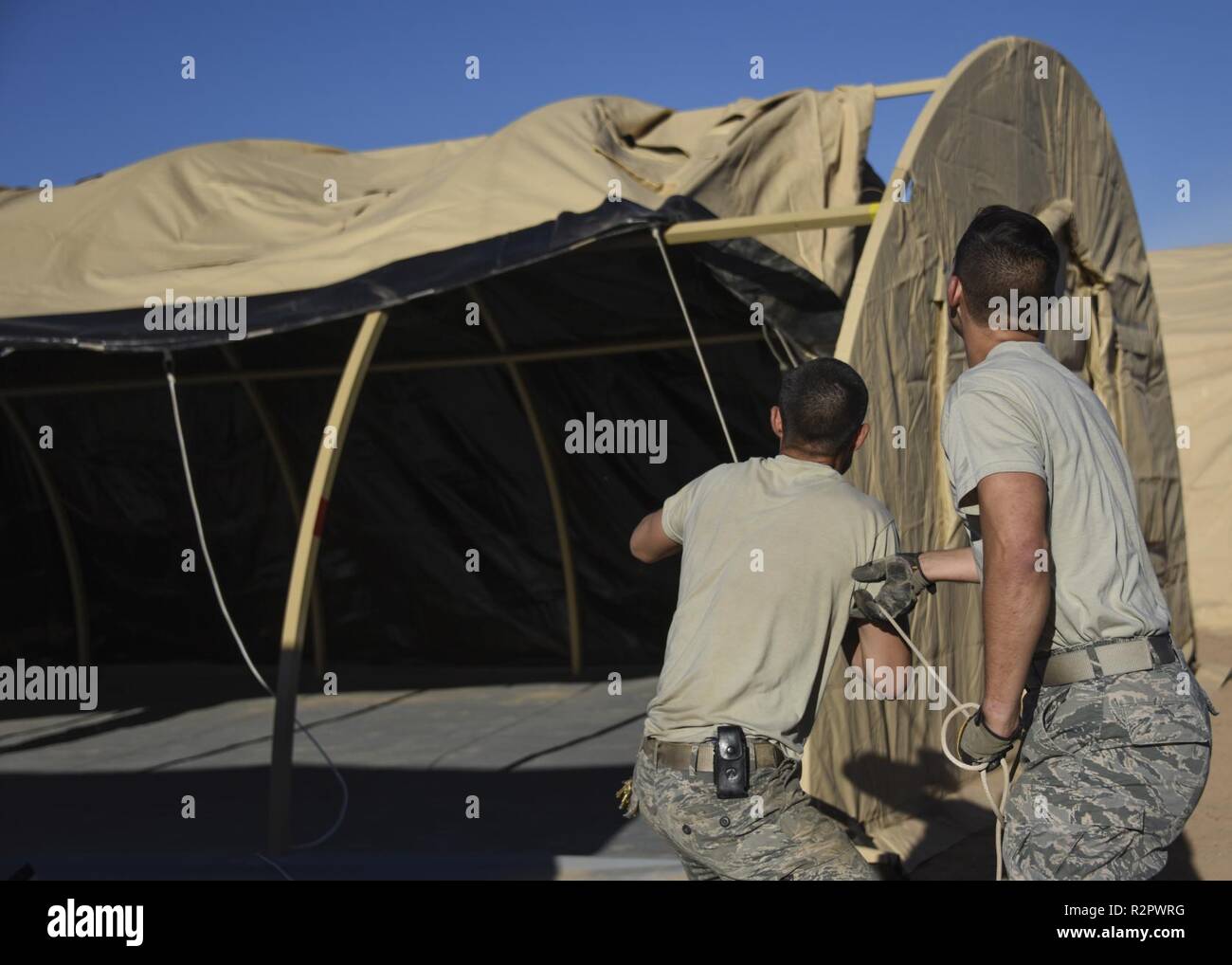 U.S. Air Force Airmen work together to set up tents for Sunglow City at ...