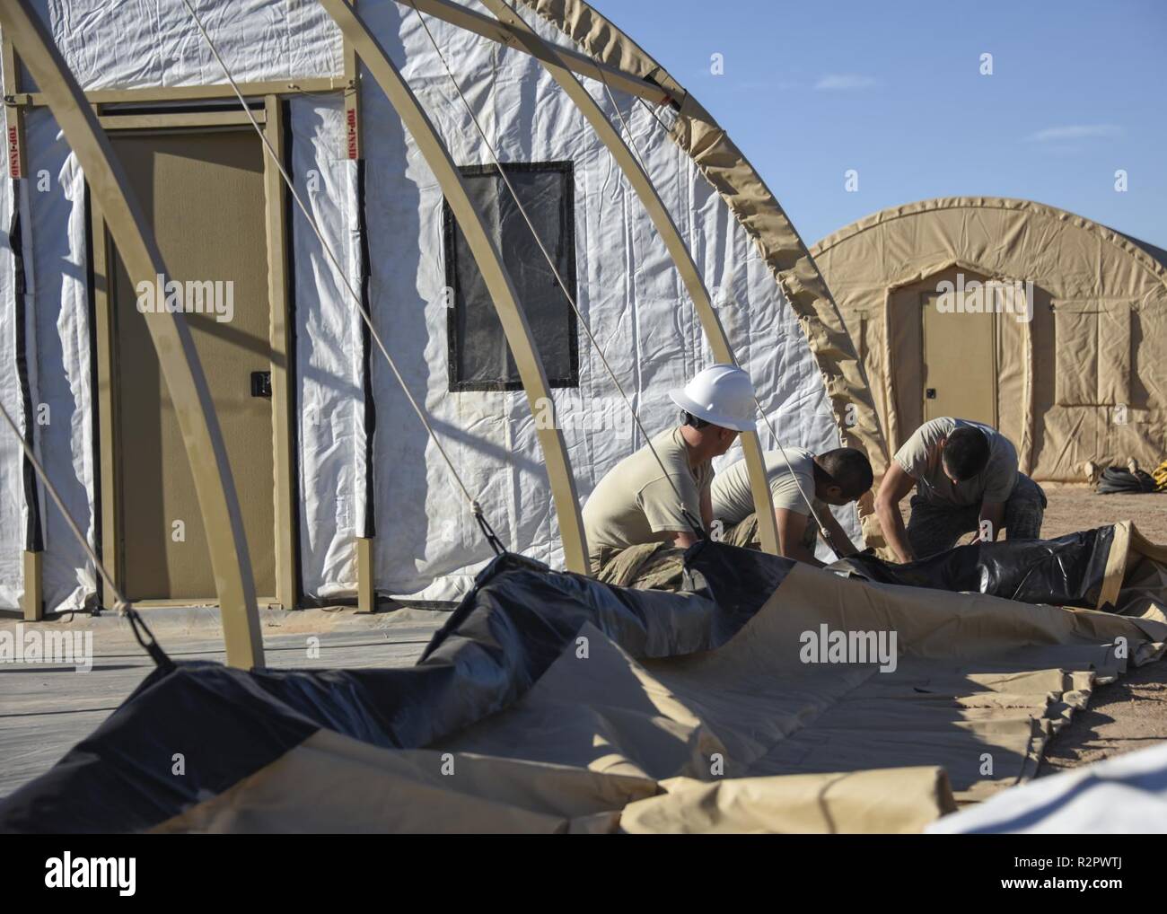 U.S. Air Force Airmen work together to set up tents for Sunglow City at ...