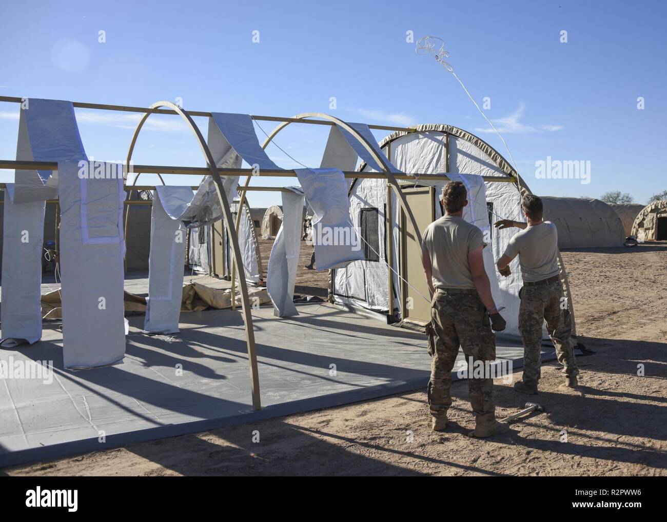 U.S. Air Force Airmen work together to set up tents for Sunglow City at ...