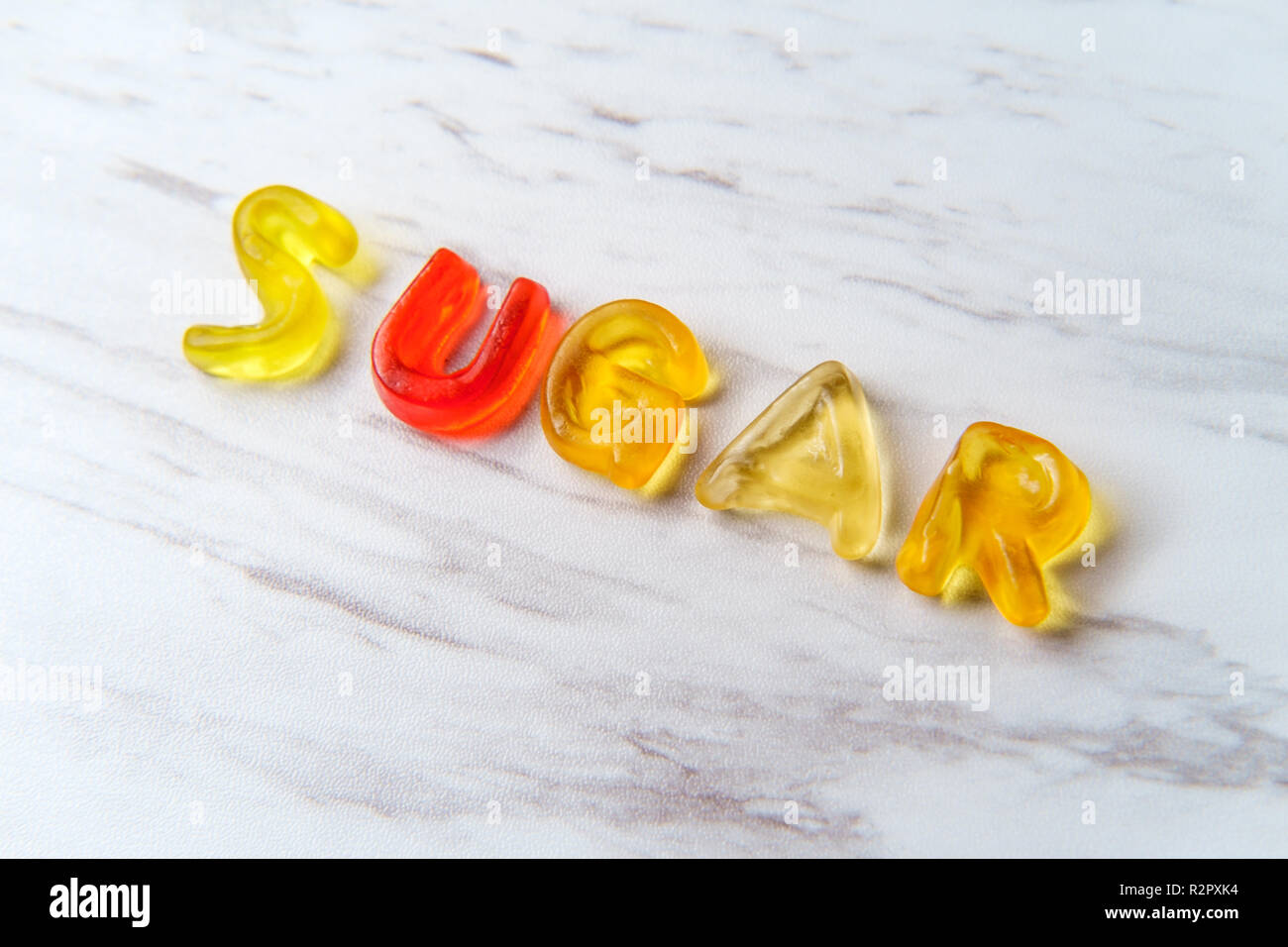 Assorted colorful gummy candy letters spell the word Sugar Stock Photo ...