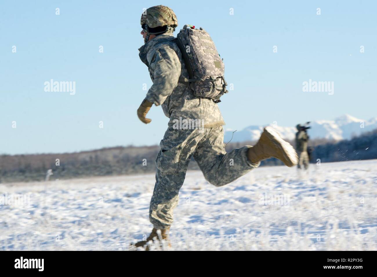 A medic runs across the drop zone to check on a soldier as paratroopers ...