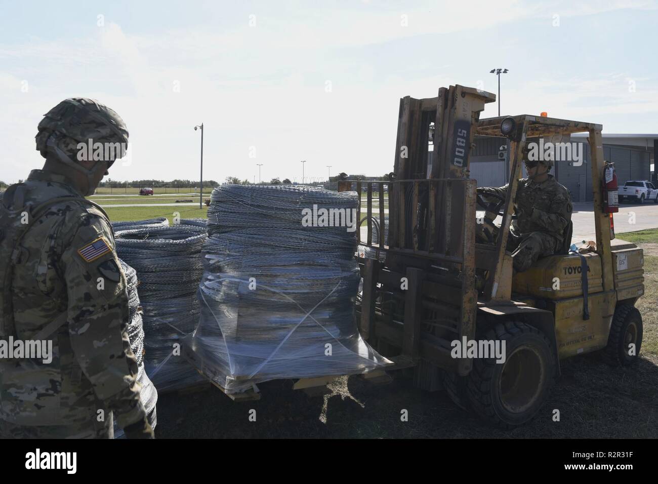 Soldiers load concertina wire into a truck Nov. 5, 2018, which will be ...