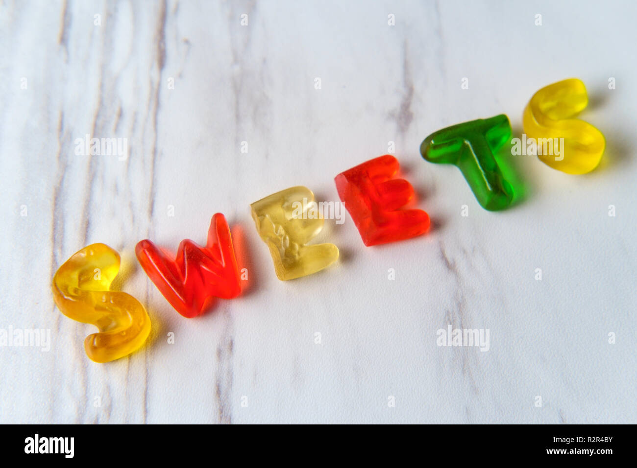 Assorted colorful gummy candy letters spell the word Sweets Stock Photo ...