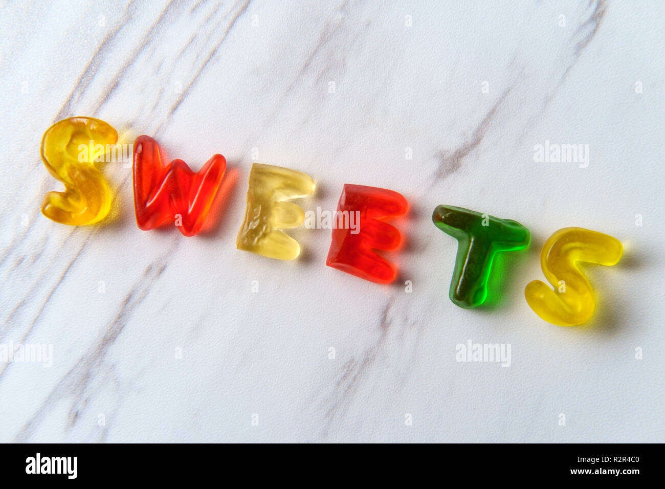Assorted colorful gummy candy letters spell the word Sweets Stock Photo ...