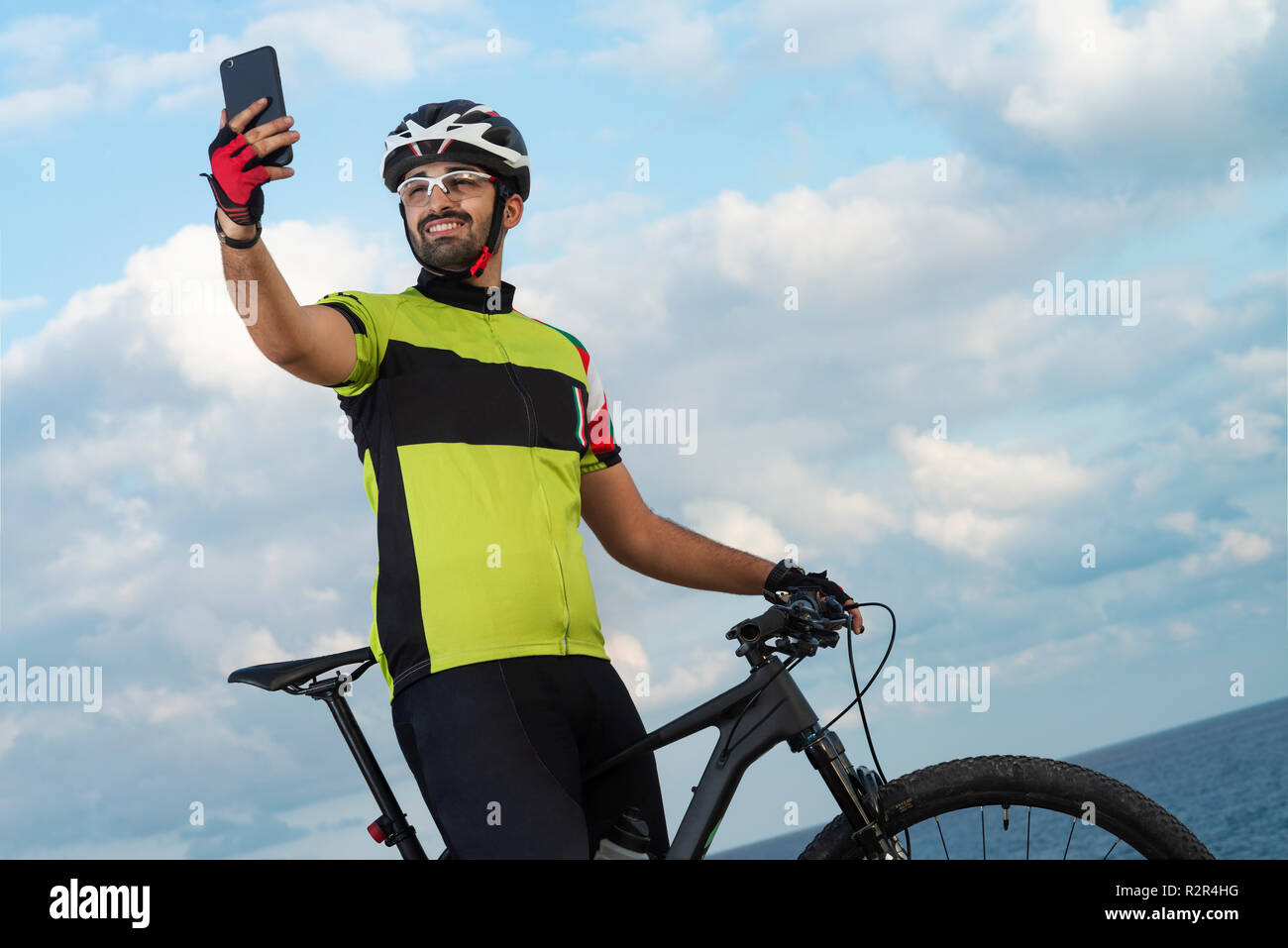 cyclist takes photo with his phone Stock Photo - Alamy