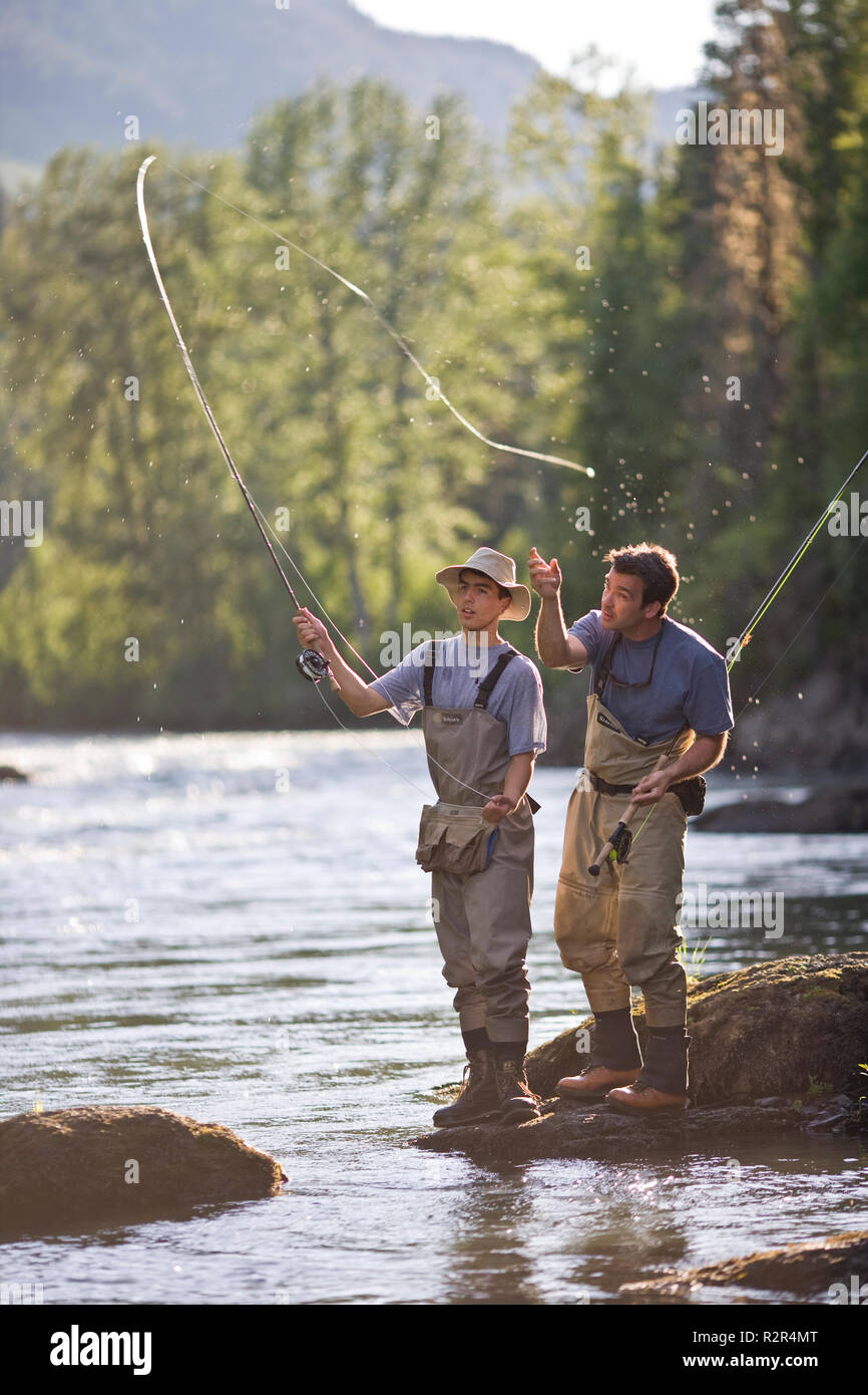 Men fishing on river Stock Photo - Alamy