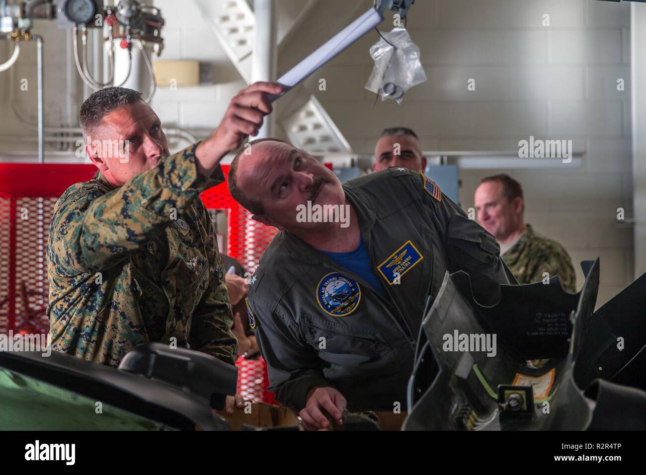 U.S. Marine Corps Master Gunnery Sgt. Travis Dusenberry, left ...