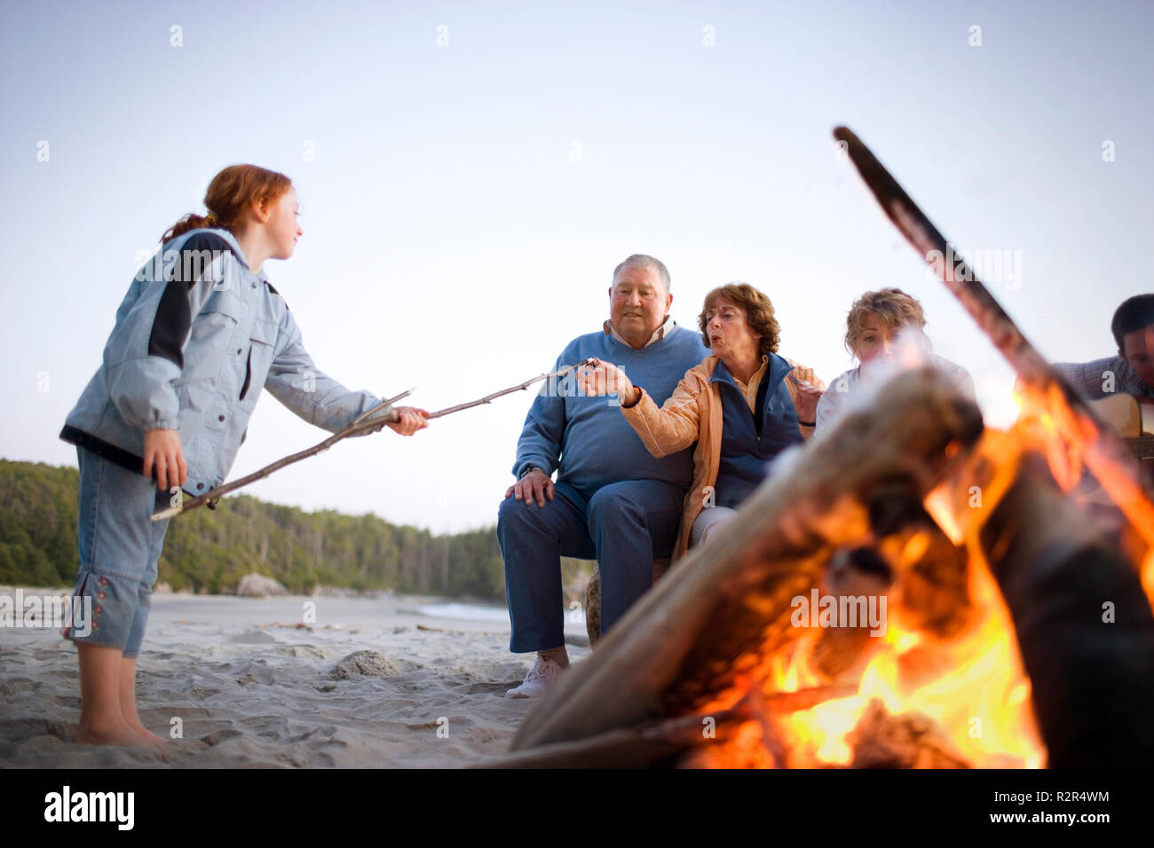 Girl sitting around campfire hi-res stock photography and images - Alamy