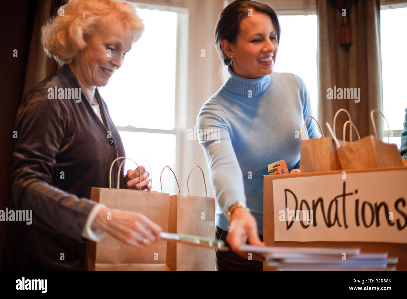 Mother and daughter doing charity work Stock Photo - Alamy