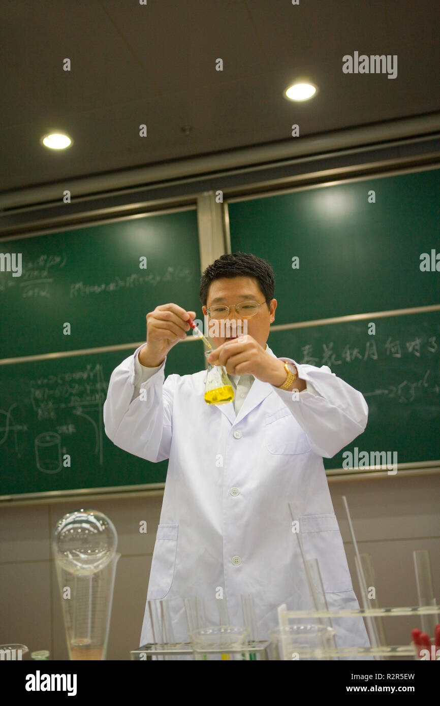 Mid-adult male teacher teaching science Stock Photo - Alamy