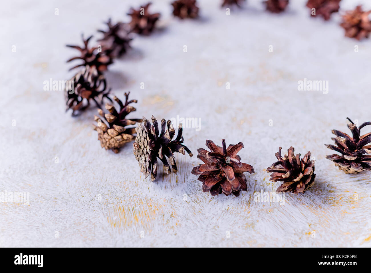 round of brown fir cones on a white background on New Year's Eve ...