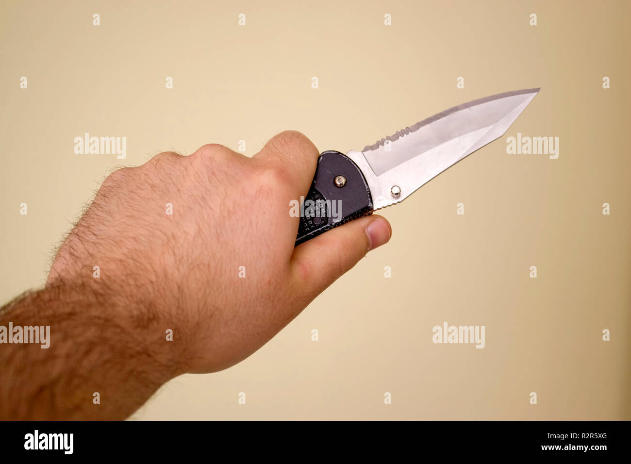 Hand holding stabbing knife hi-res stock photography and images - Alamy