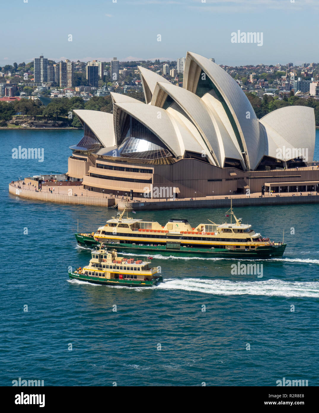 Sydney Harbour and ferries passing the Sydney Opera House Bennelong ...