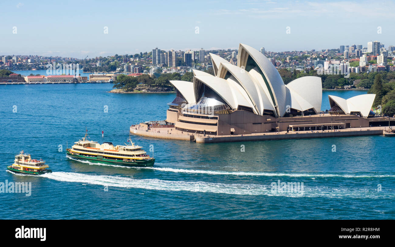 Sydney Harbour and ferries passing the Sydney Opera House Bennelong ...