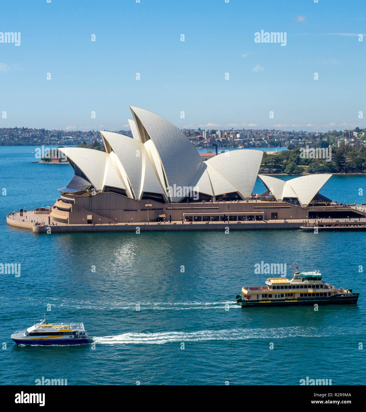 Sydney Harbour and ferries passing the Sydney Opera House Bennelong ...