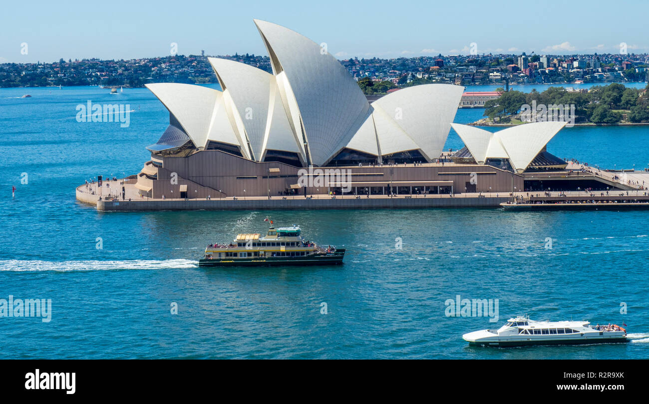 Sydney Harbour and ferries passing the Sydney Opera House Bennelong ...