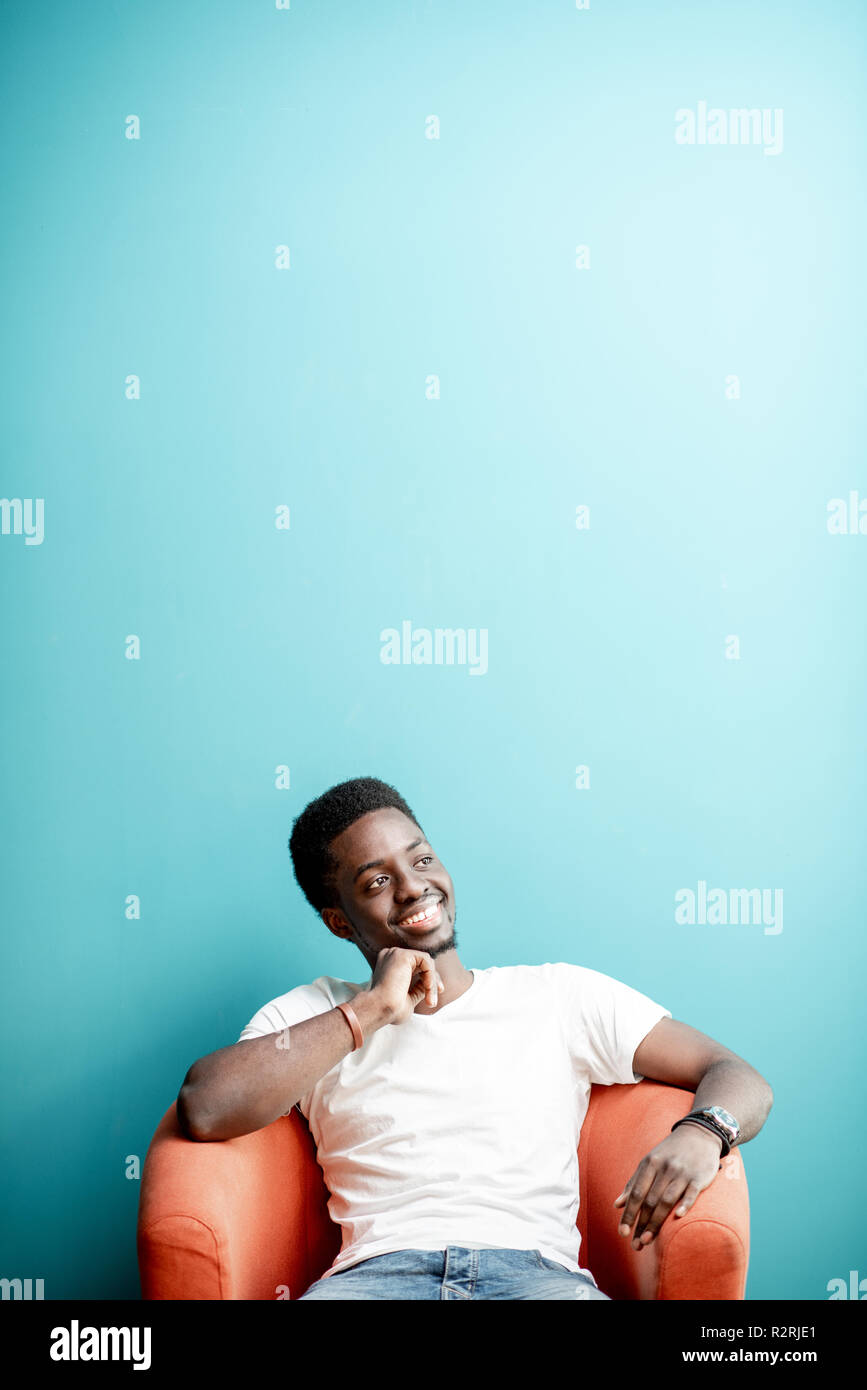 Portrait of a young african man dressed in white t-shirt and jeans ...