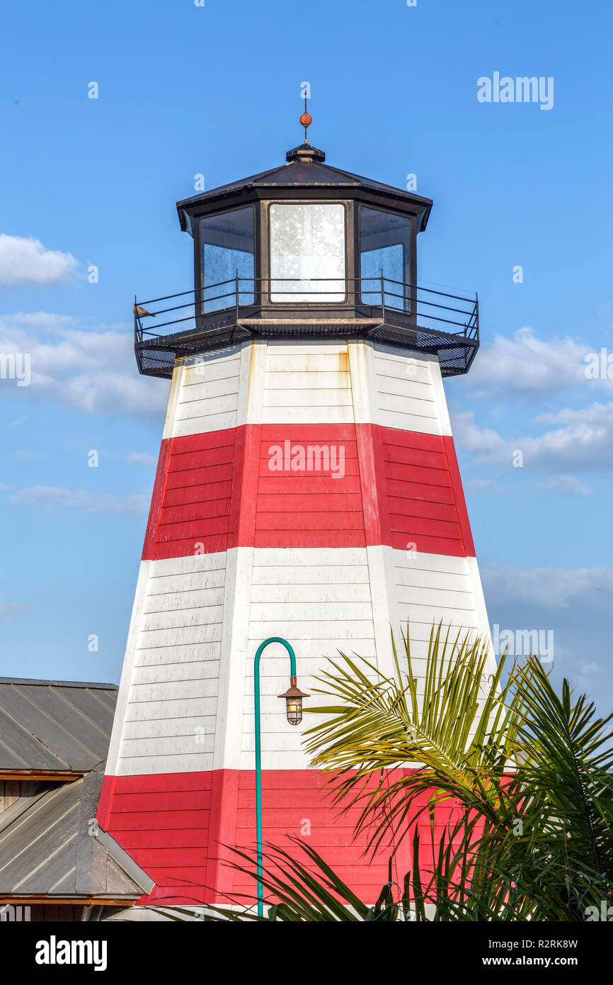 This red an white replica lighthouse overlooks a boardwalk in Madeira ...