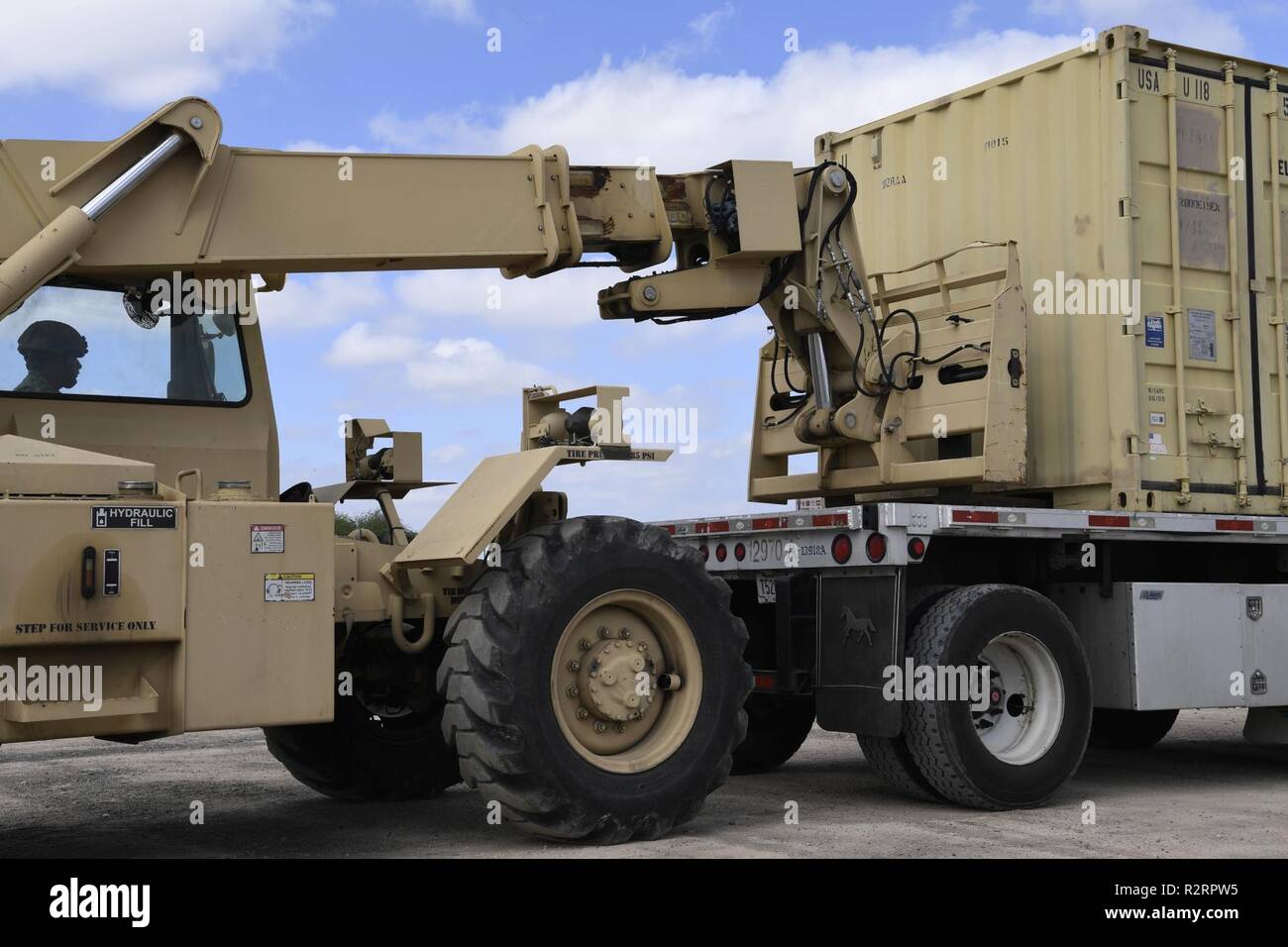 A Soldier operates a forklift to remove a supply container off a truck ...