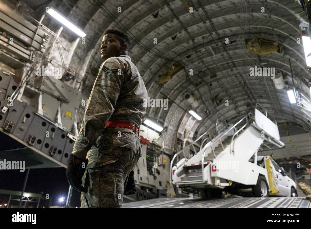 Senior Airman Xavier Clark, 60th Aerial Port Squadron, waits to secure ...