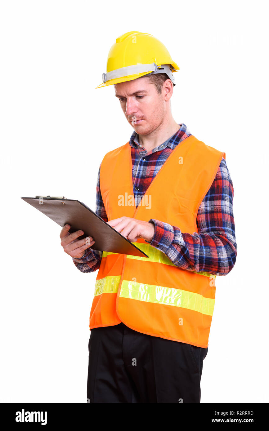 Studio shot of man construction worker reading on clipboard Stock Photo ...