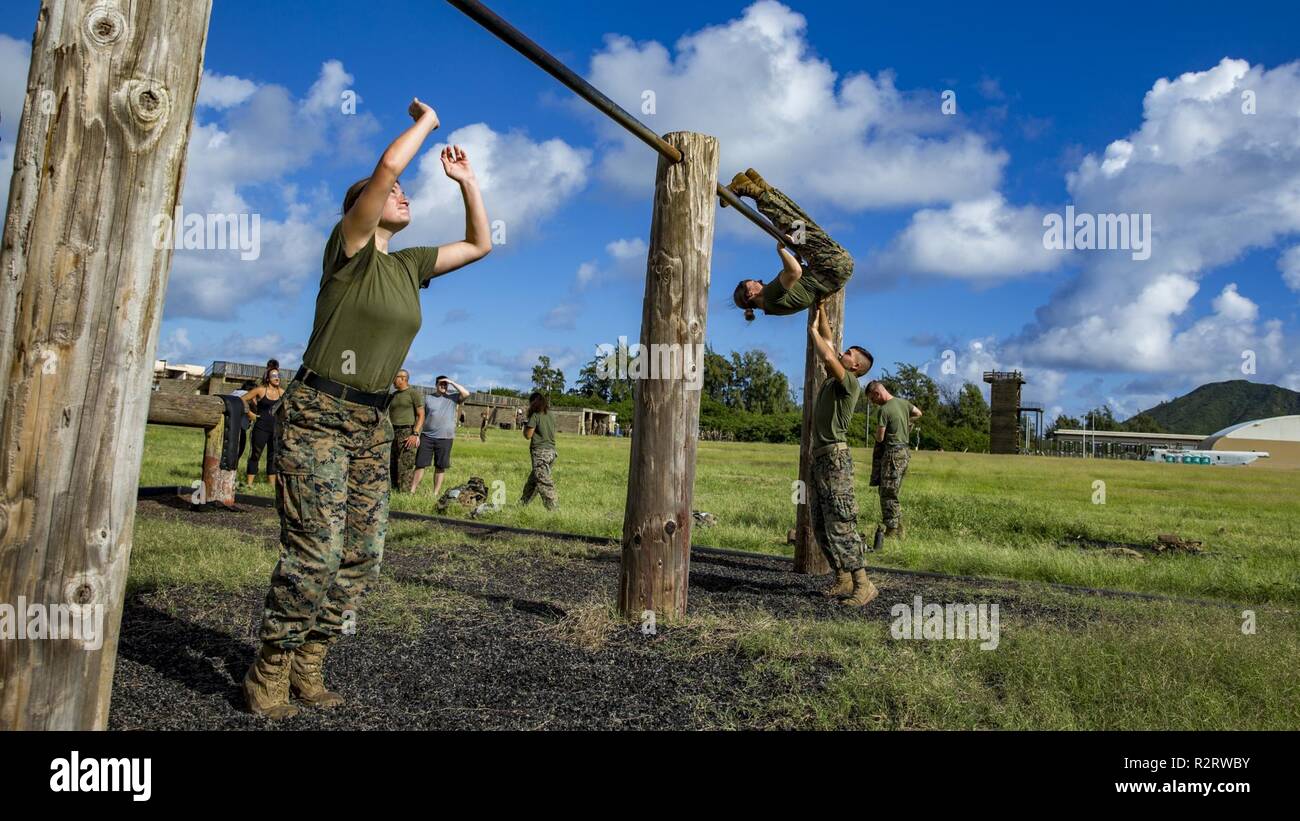 U.S. Marine spouses maneuver through an obstacle course during a Wahine ...