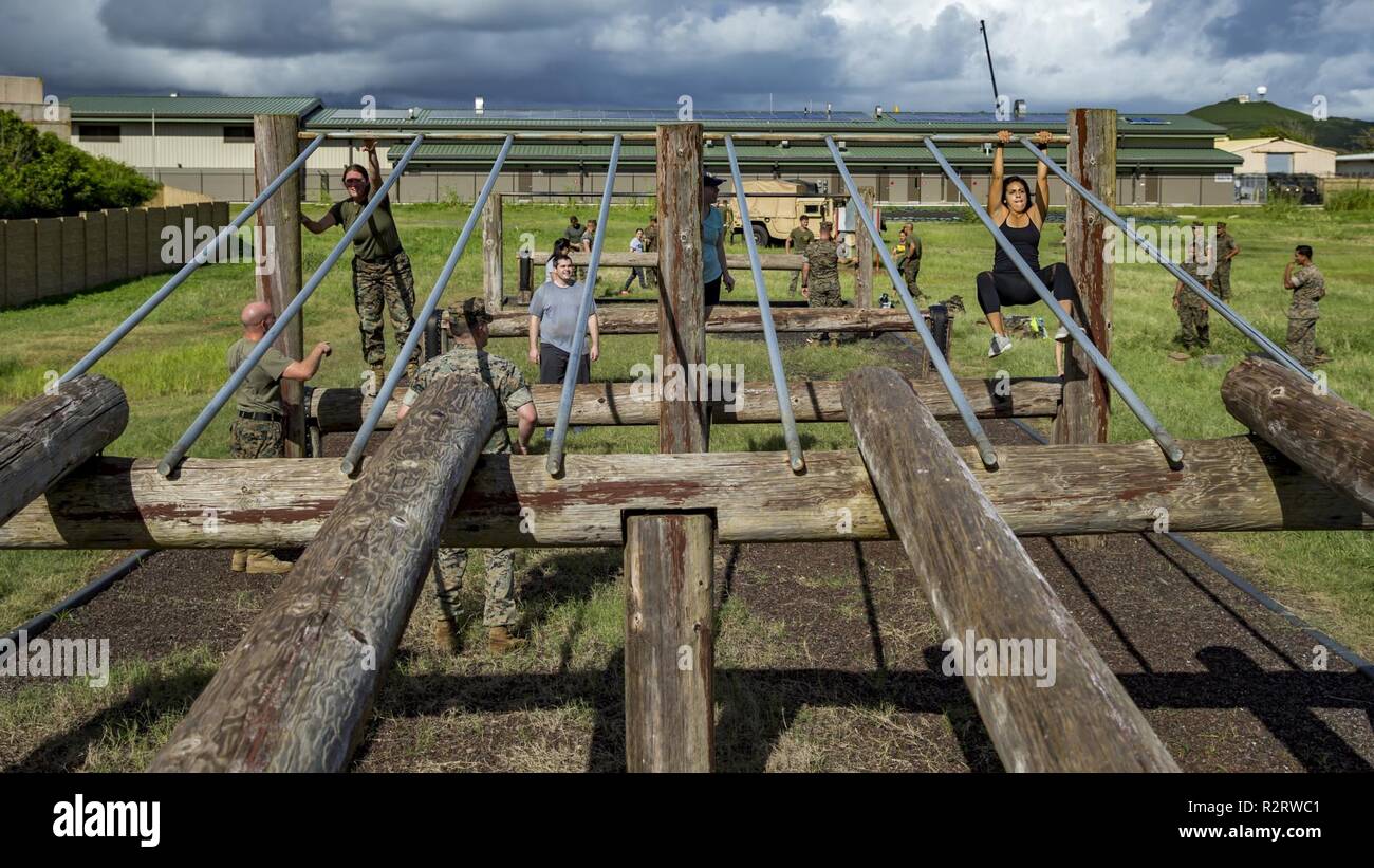 U.S. Marine spouses maneuver through an obstacle course during a Wahine ...