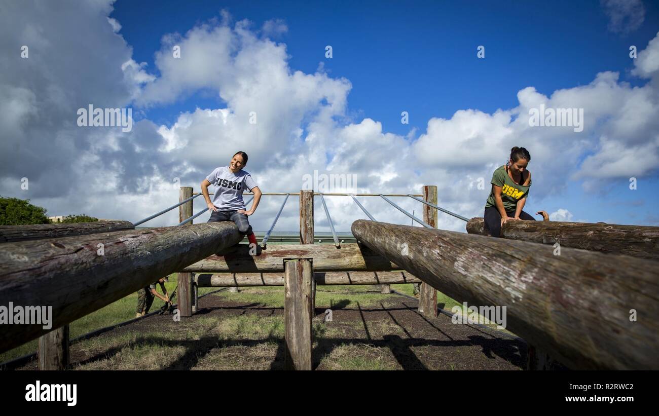 U.S. Marine spouses maneuver through an obstacle course during a Wahine ...
