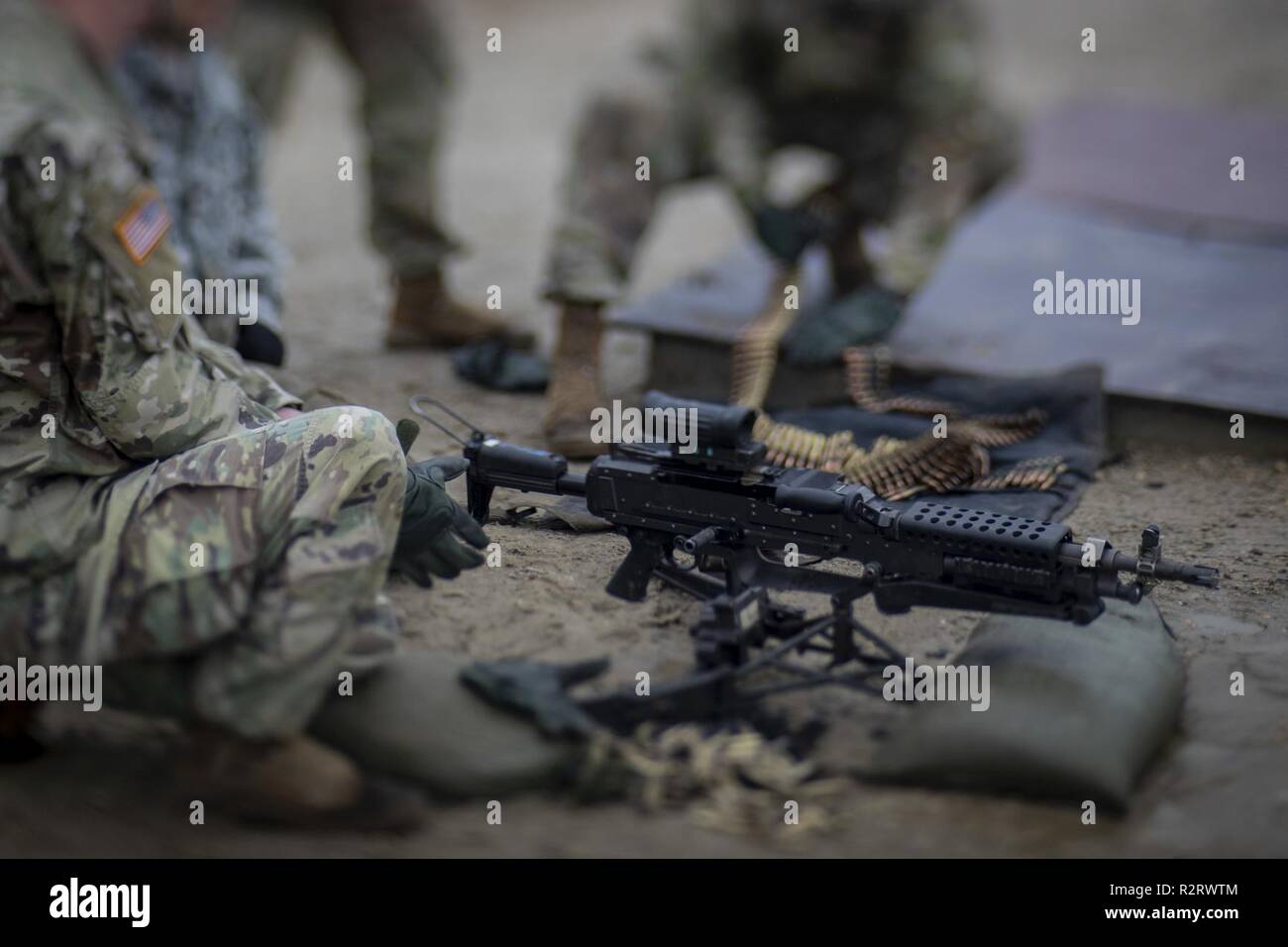 U.S. Army Soldiers from the 1-114th Infantry Regiment prep an M240 ...