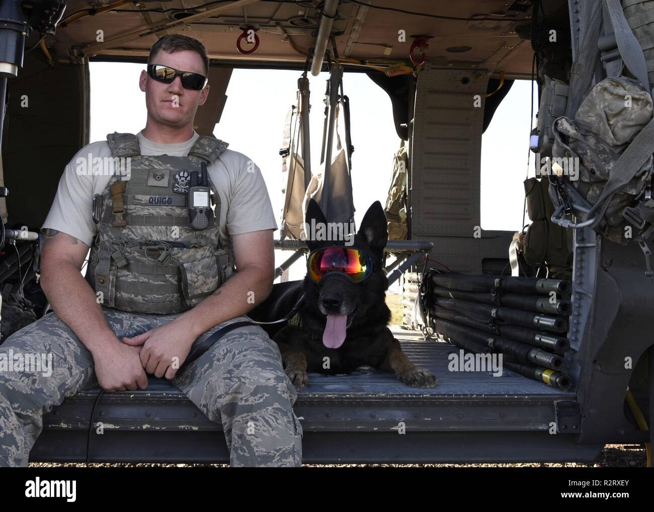 Staff Sgt. Kyle Quigg, 56th Security Forces Squadron kennel master, poses for a photo with a ...