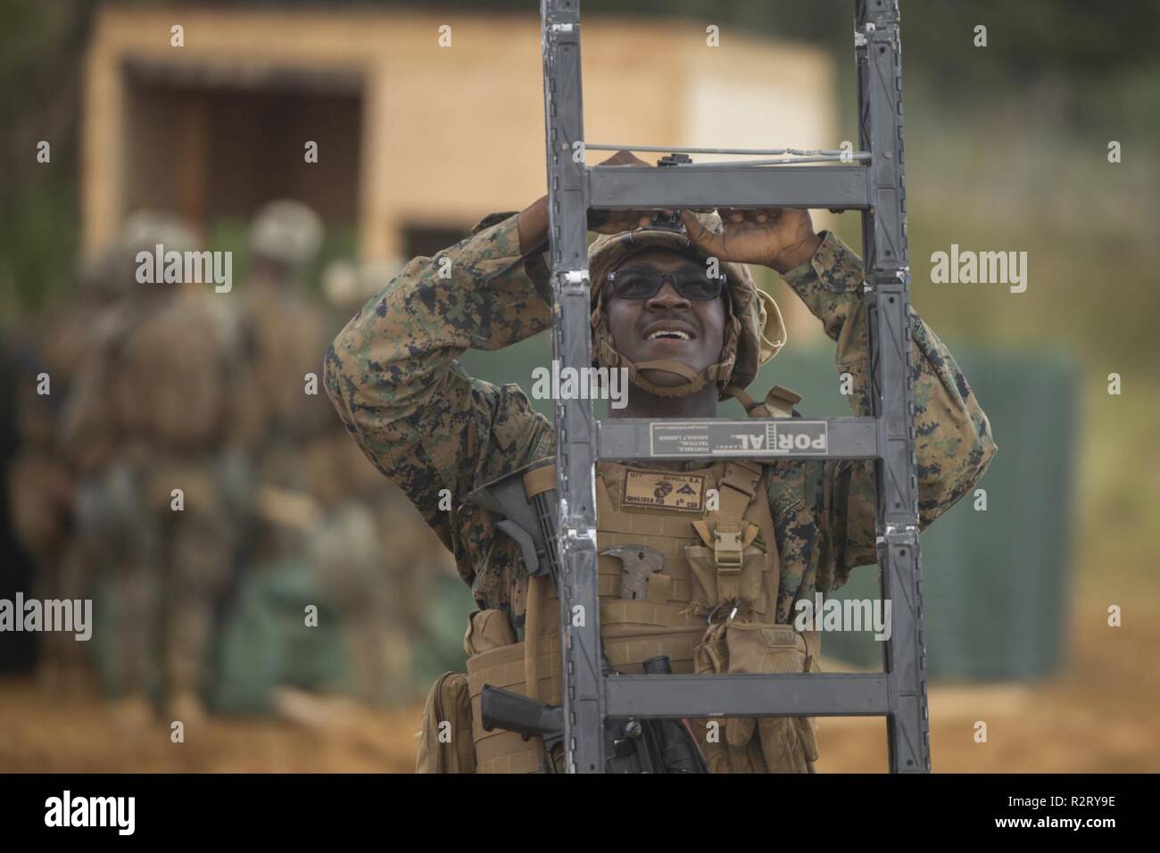 Lance Cpl. Shakeel Bovell prepares a ladder to reinforce a defensive ...